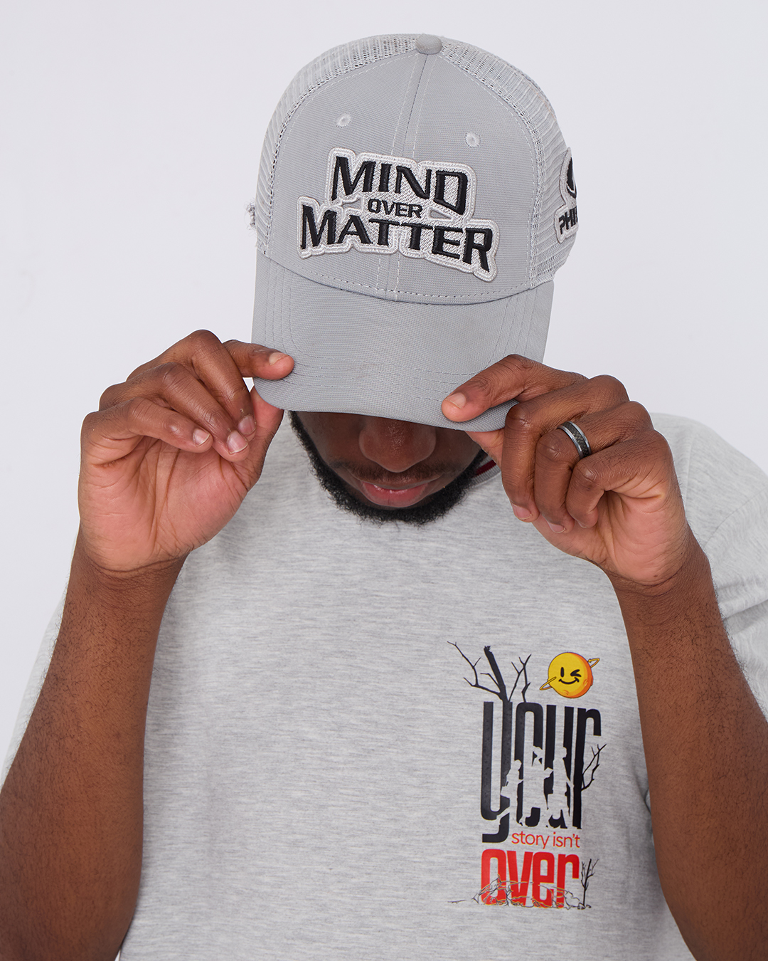 Gray cap with "MIND OVER MATTER" embroidered in black and white ...